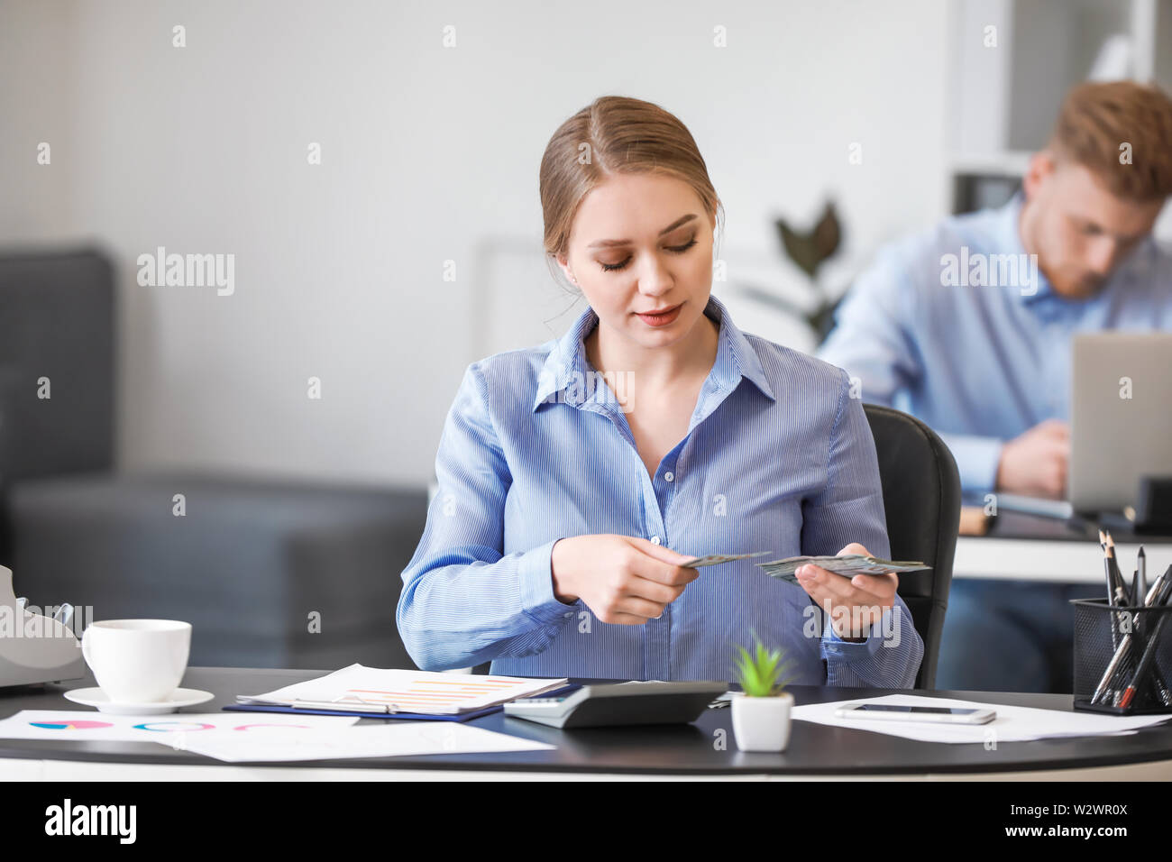 Female accountant working in office Stock Photo - Alamy