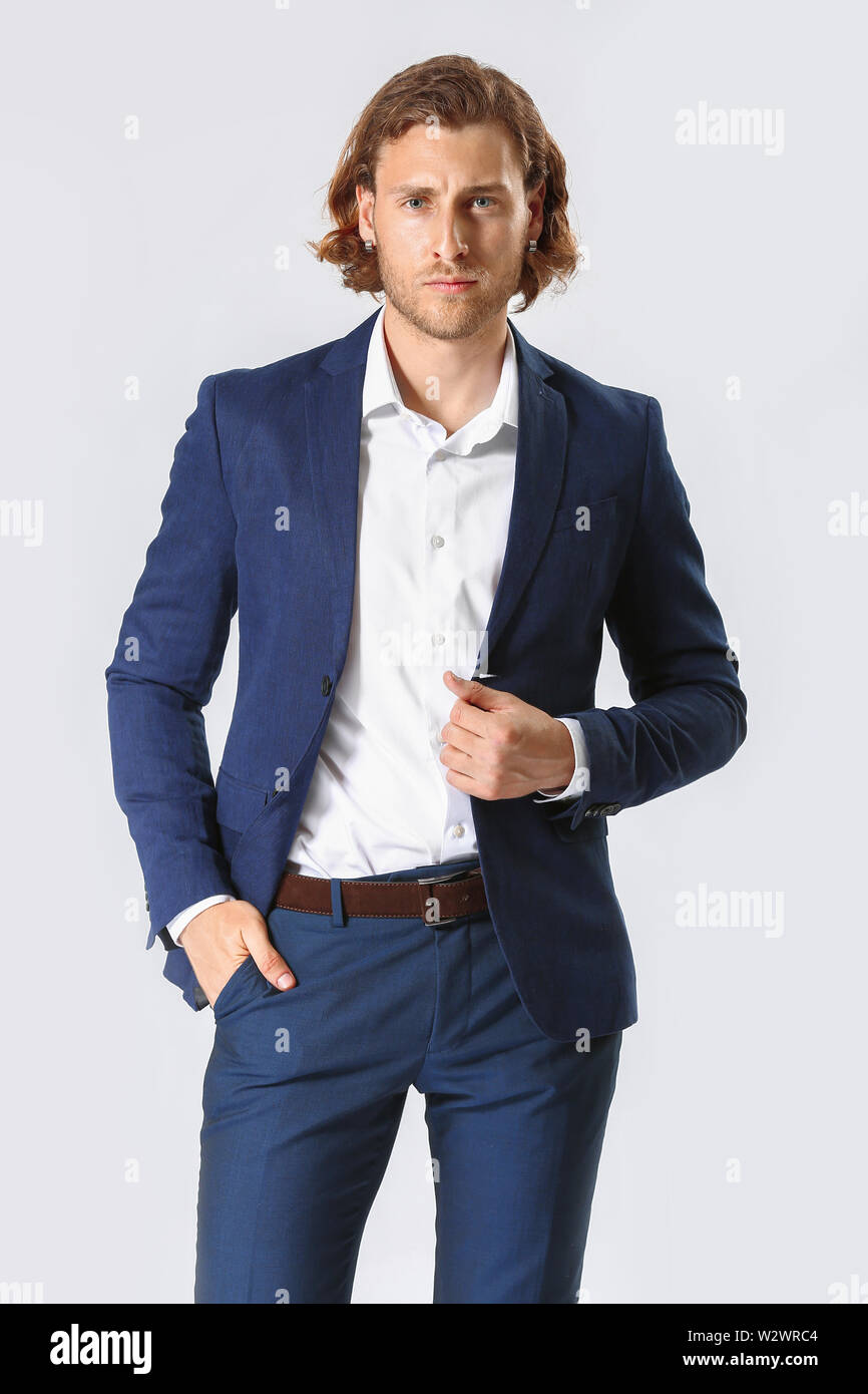 Stylish young man in formal clothes on white background Stock Photo - Alamy
