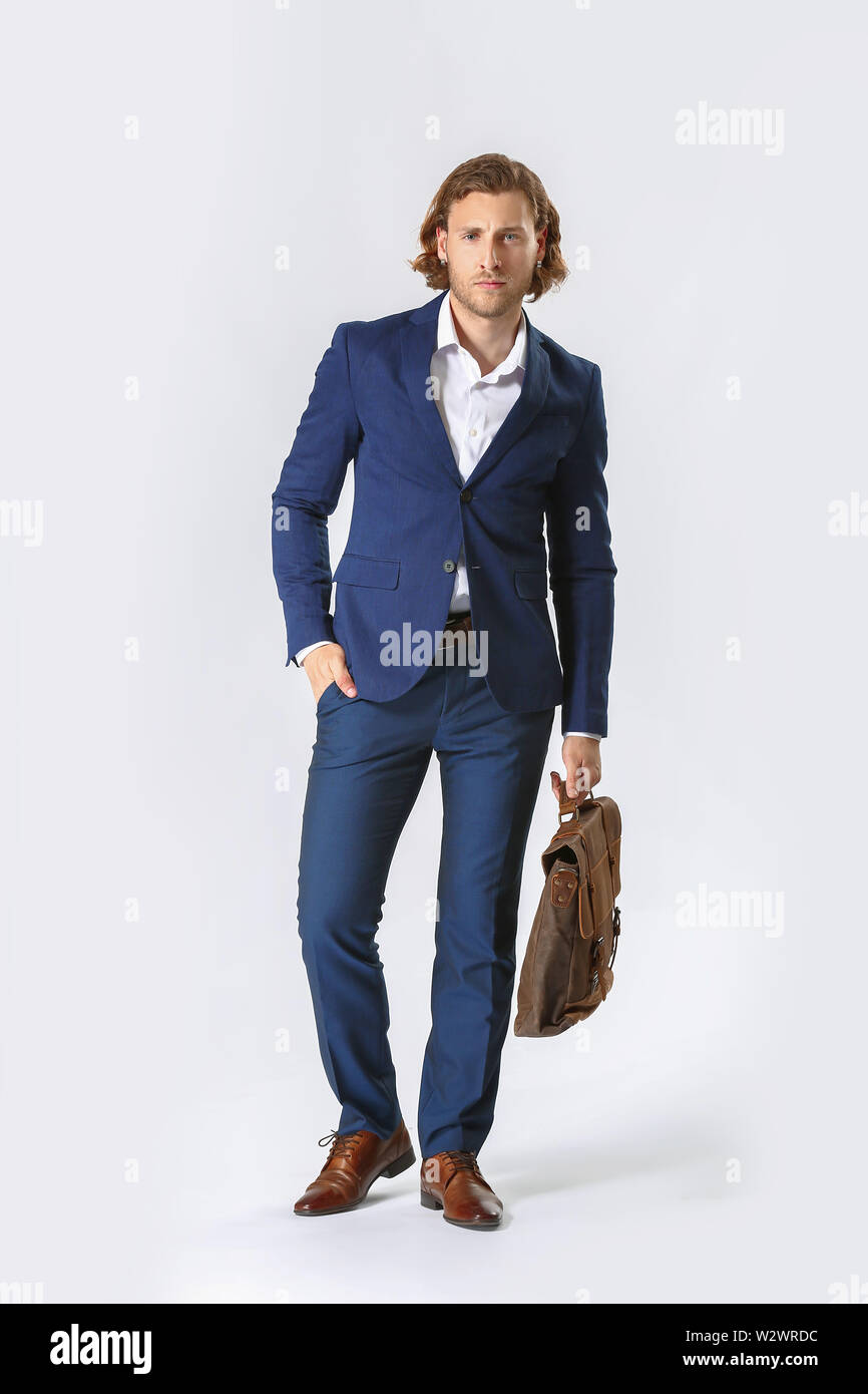 Stylish young man in formal clothes on white background Stock Photo - Alamy
