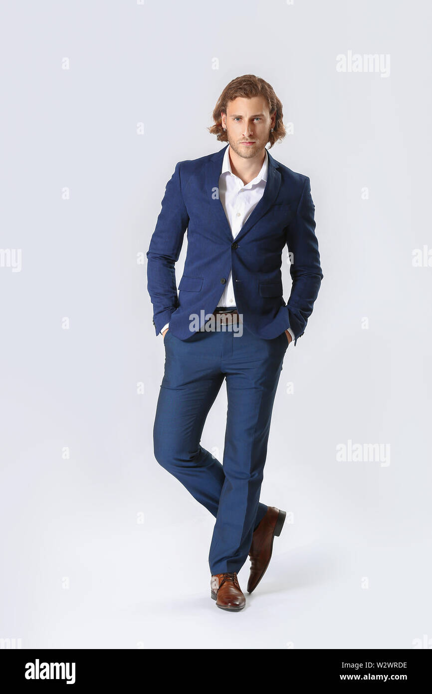 Stylish young man in formal clothes on white background Stock Photo - Alamy