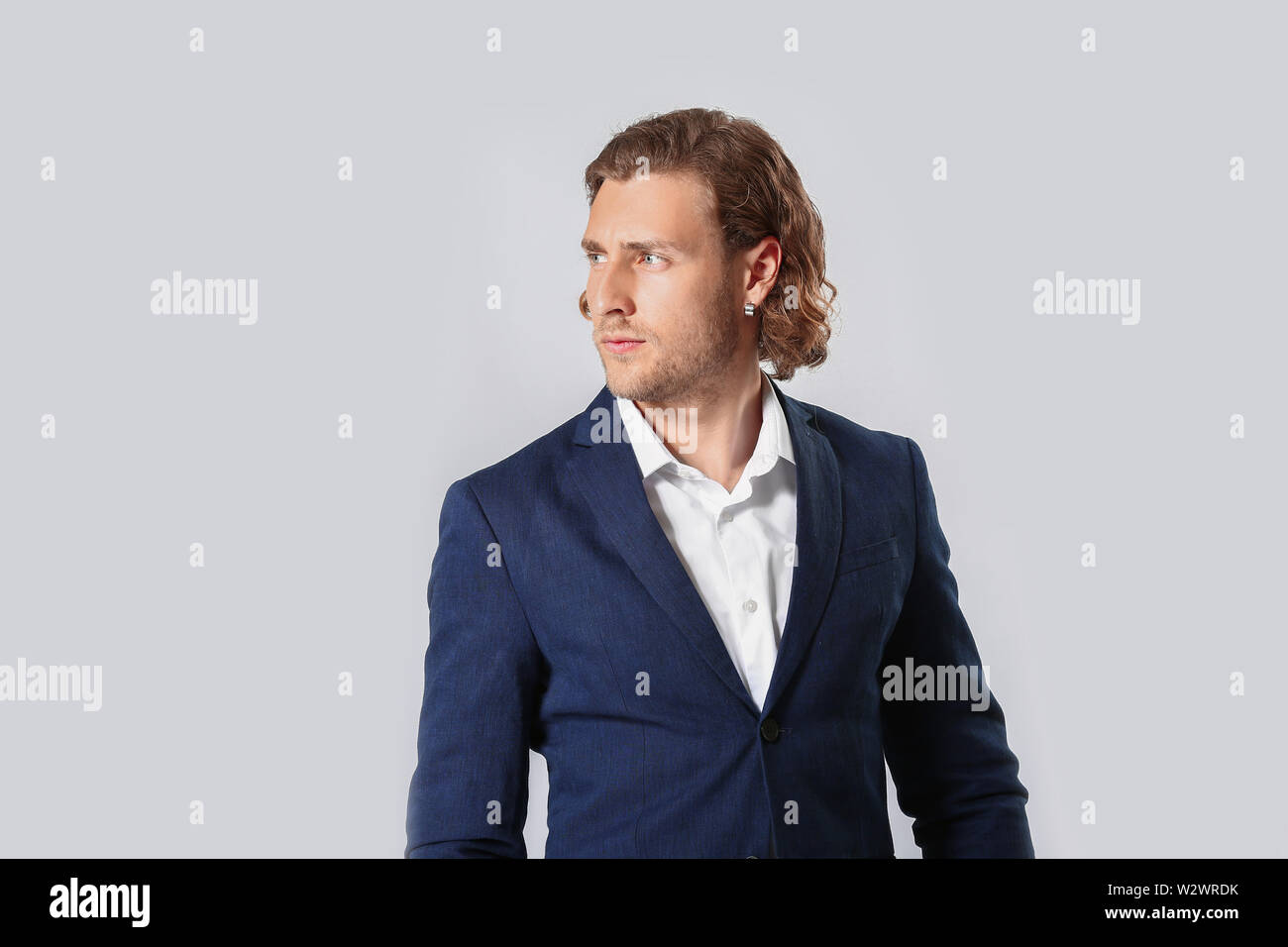 Stylish young man in formal clothes on white background Stock Photo - Alamy