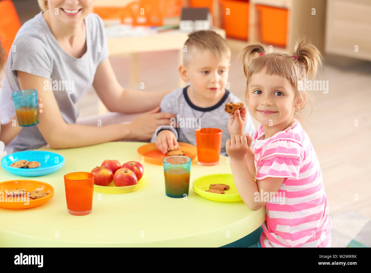 Cute little children eating tasty lunch in kindergarten Stock Photo - Alamy