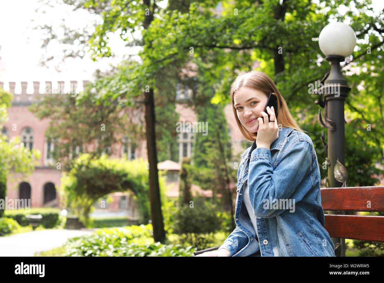 Female tourist talking by mobile phone in beautiful park Stock Photo ...