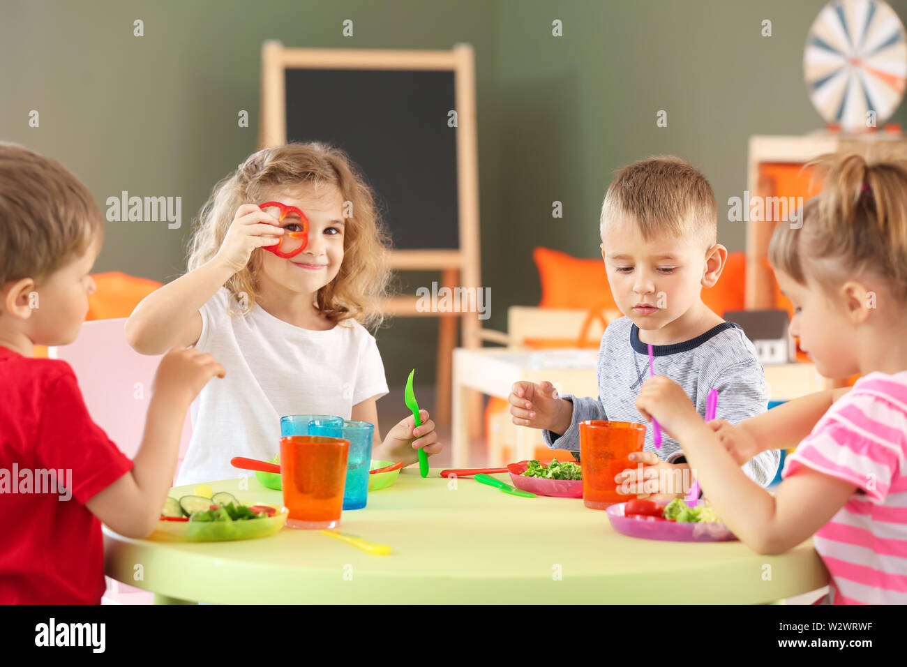 Cute little children eating tasty lunch in kindergarten Stock Photo - Alamy