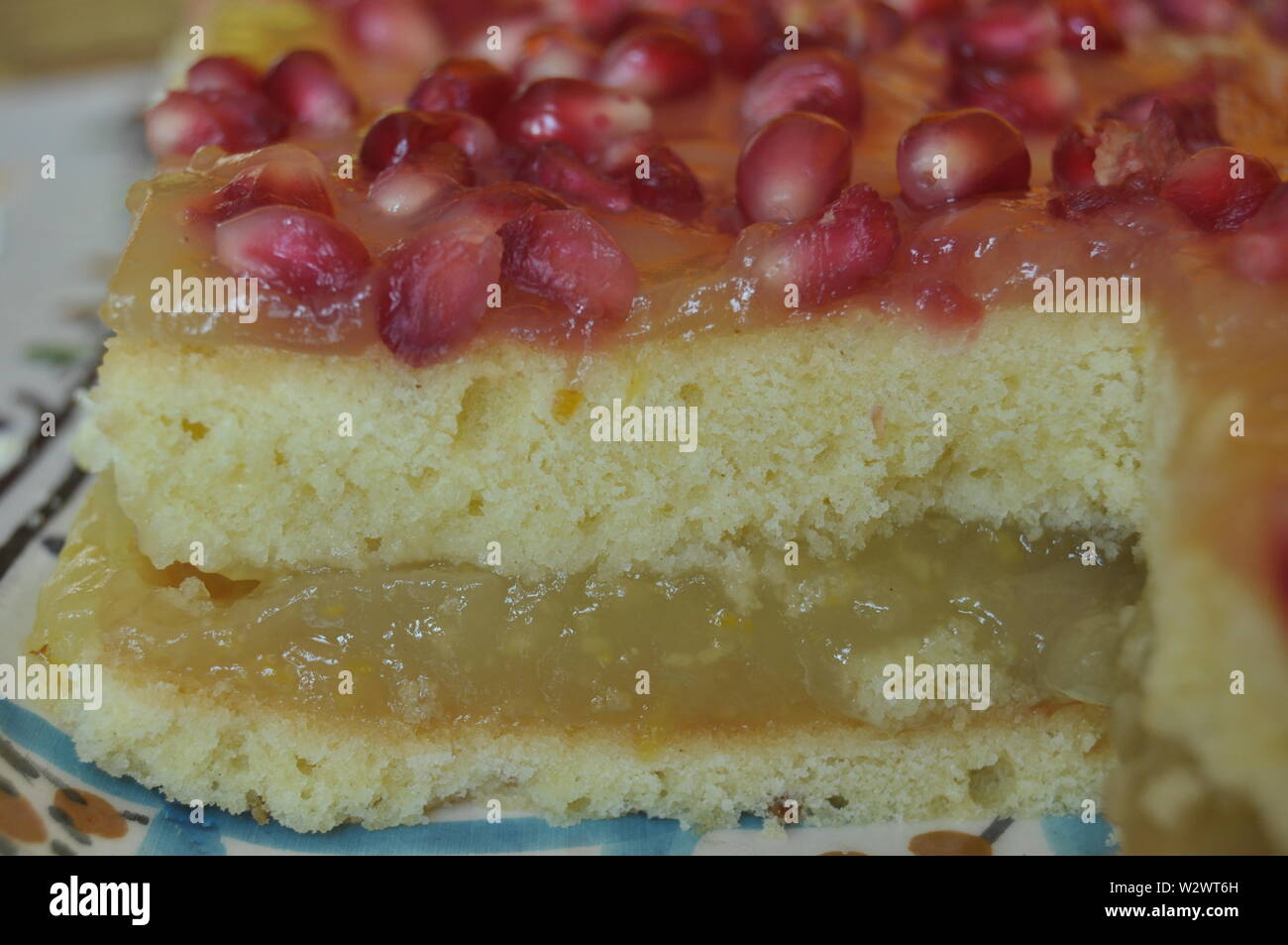 Lemon cake. With sweet icing and fruit grenade. Sweet dessert Stock ...