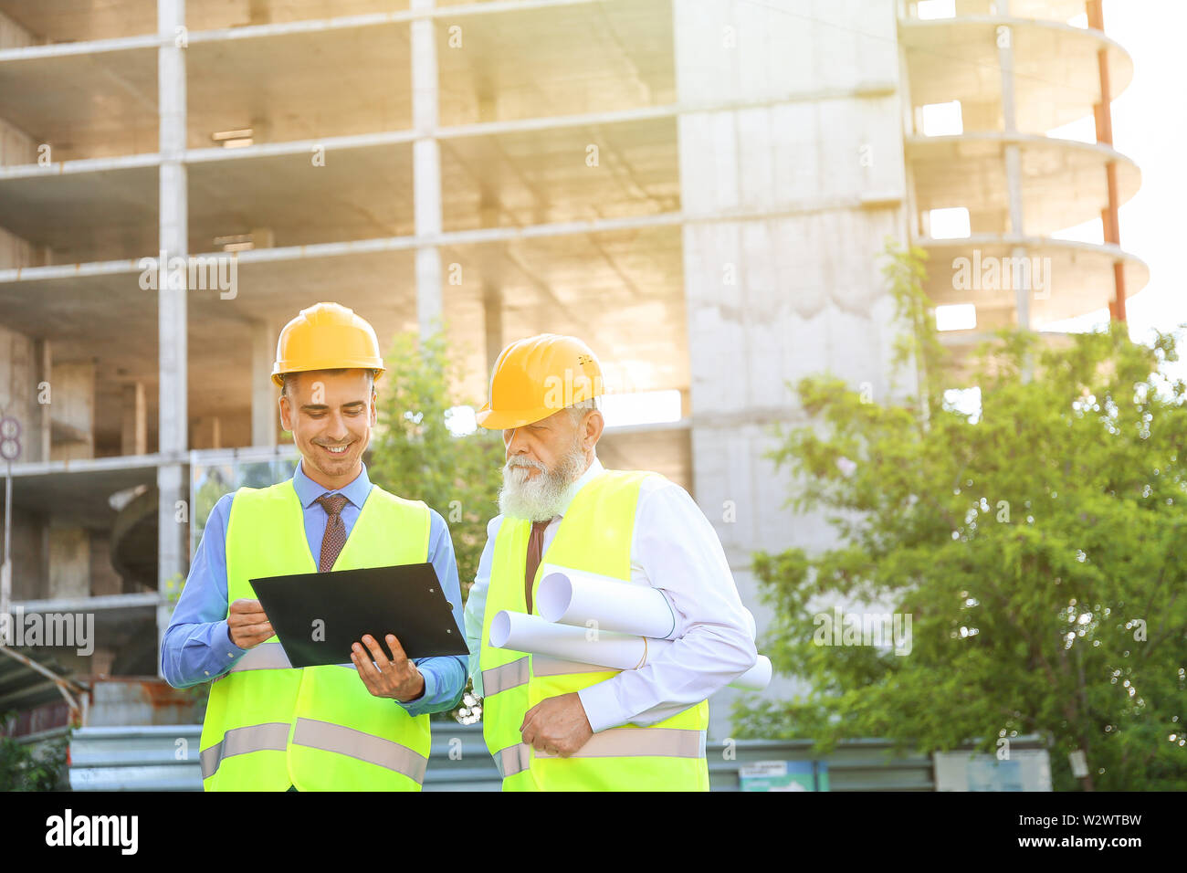Architects discussing project of building outdoors Stock Photo - Alamy