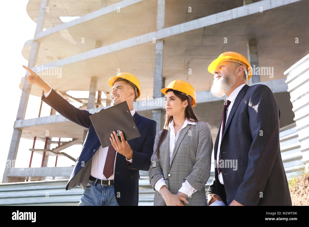Architects discussing project of building outdoors Stock Photo - Alamy