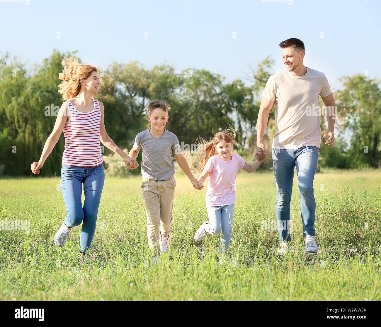 Happy family running hi-res stock photography and images - Alamy