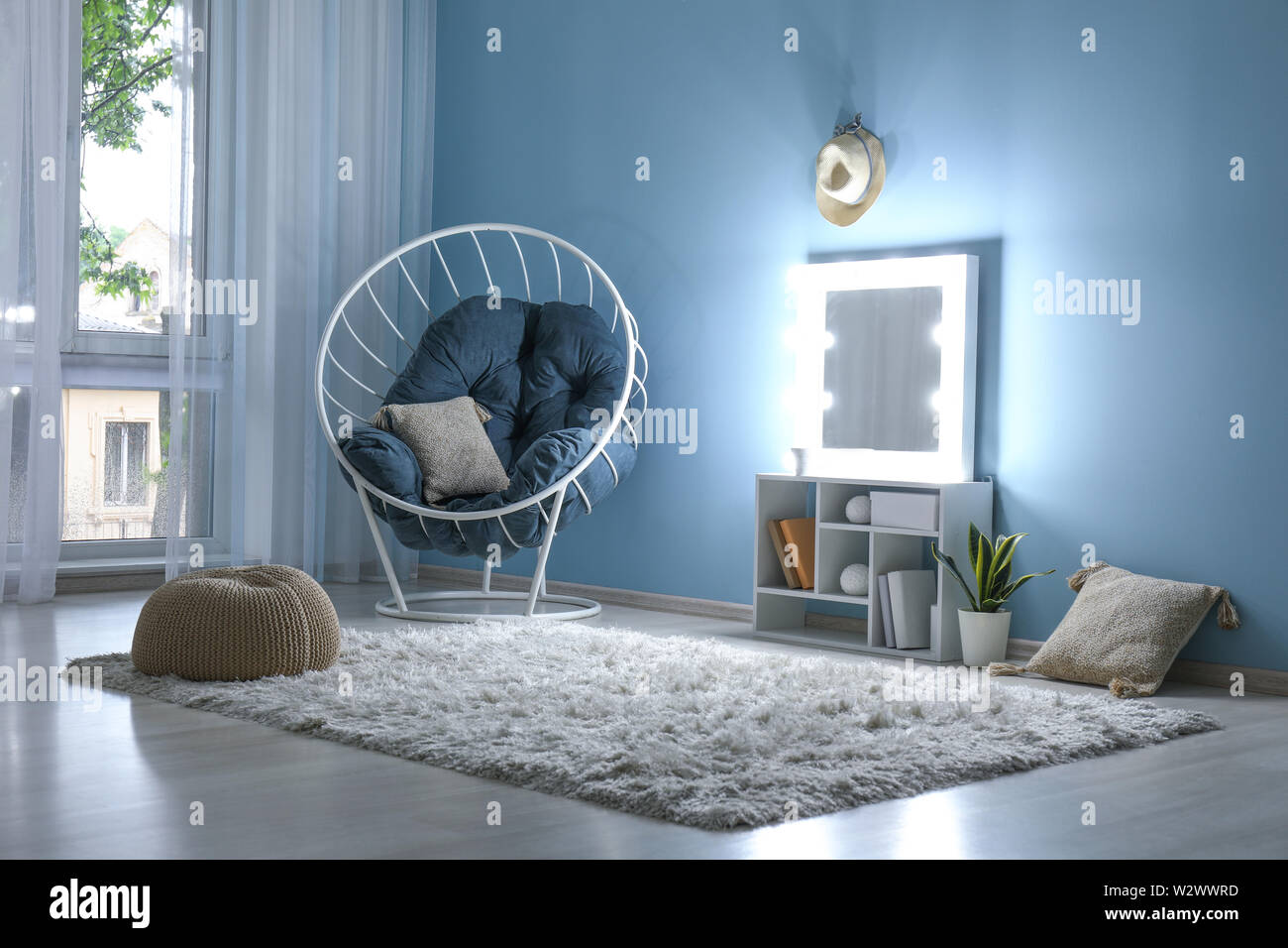 Stylish interior of room near color wall Stock Photo - Alamy