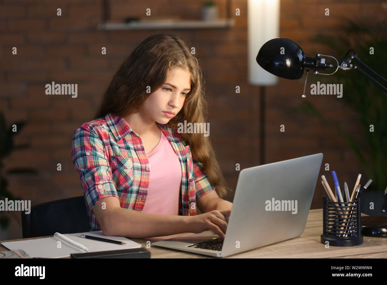 Teenage girl doing homework late in evening Stock Photo - Alamy