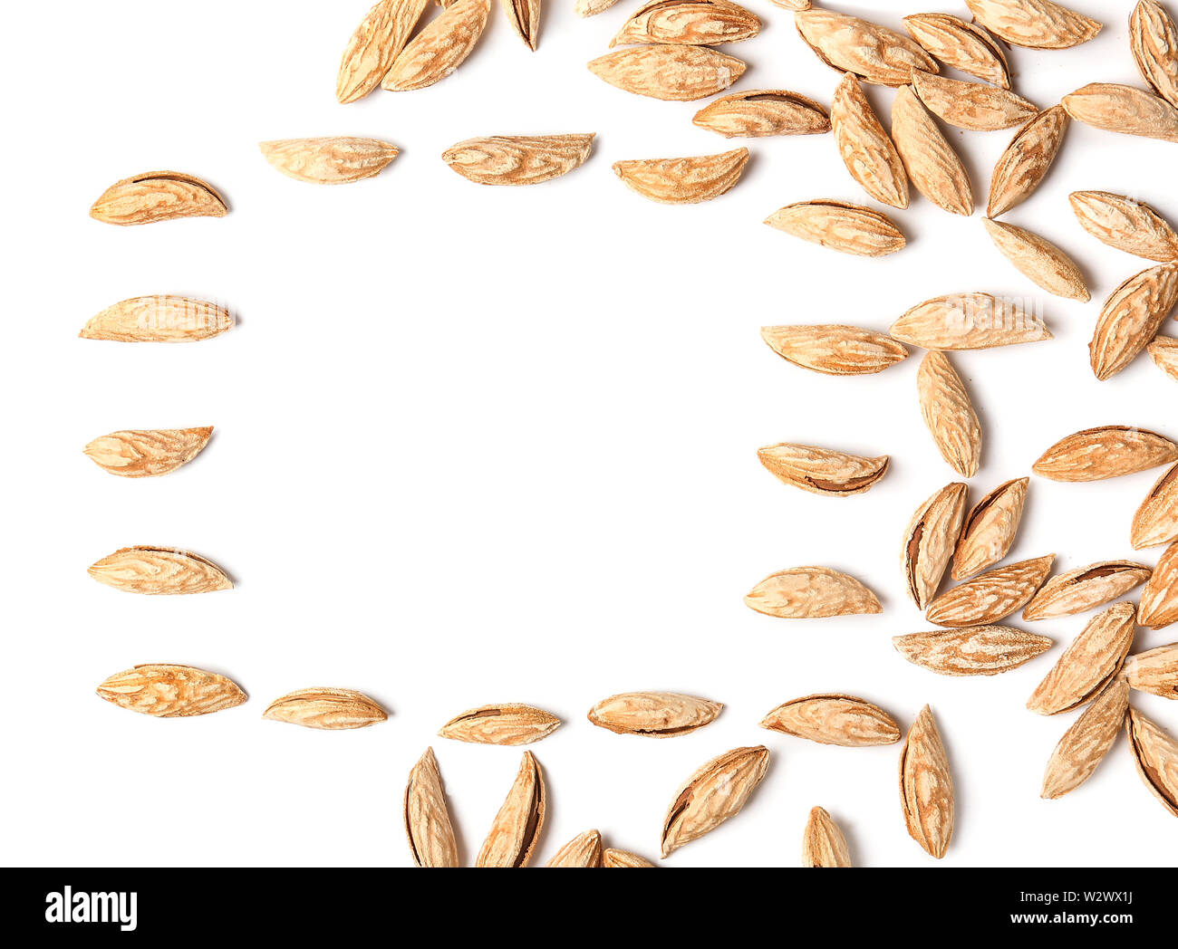 Frame made of unpeeled almond nuts on white background Stock Photo - Alamy
