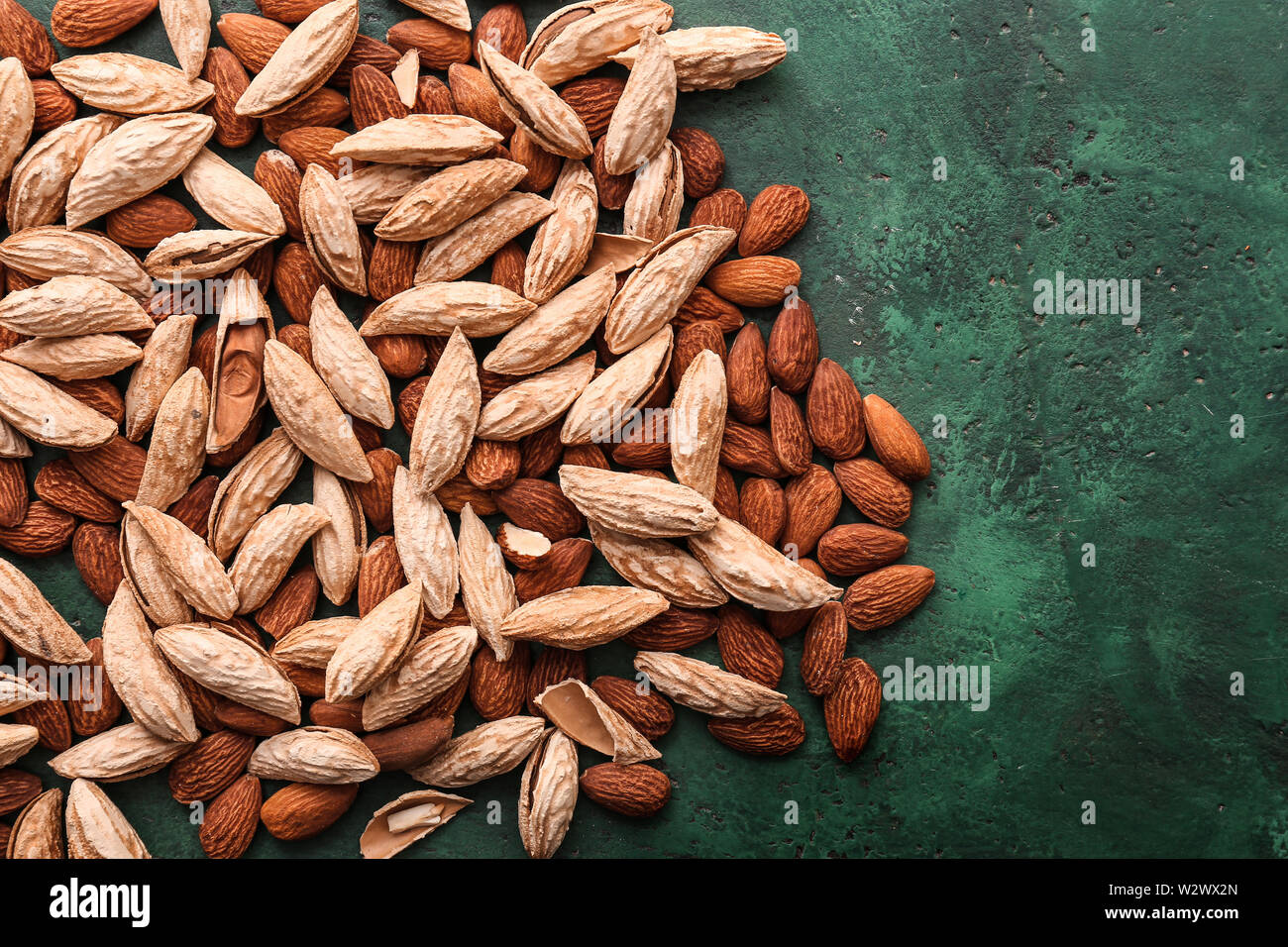 Many almonds on color background Stock Photo - Alamy