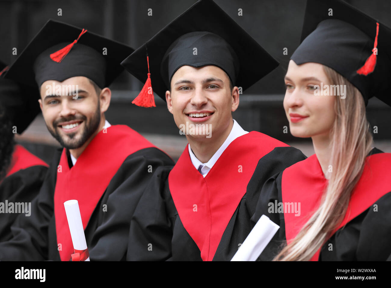 Young students in bachelor robes outdoors Stock Photo - Alamy