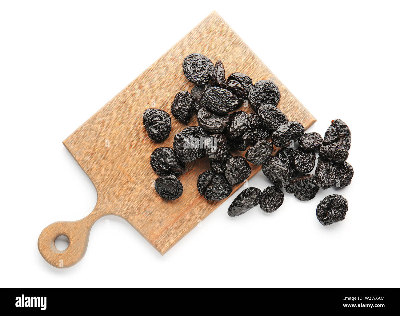 Board with tasty prunes on white background Stock Photo - Alamy