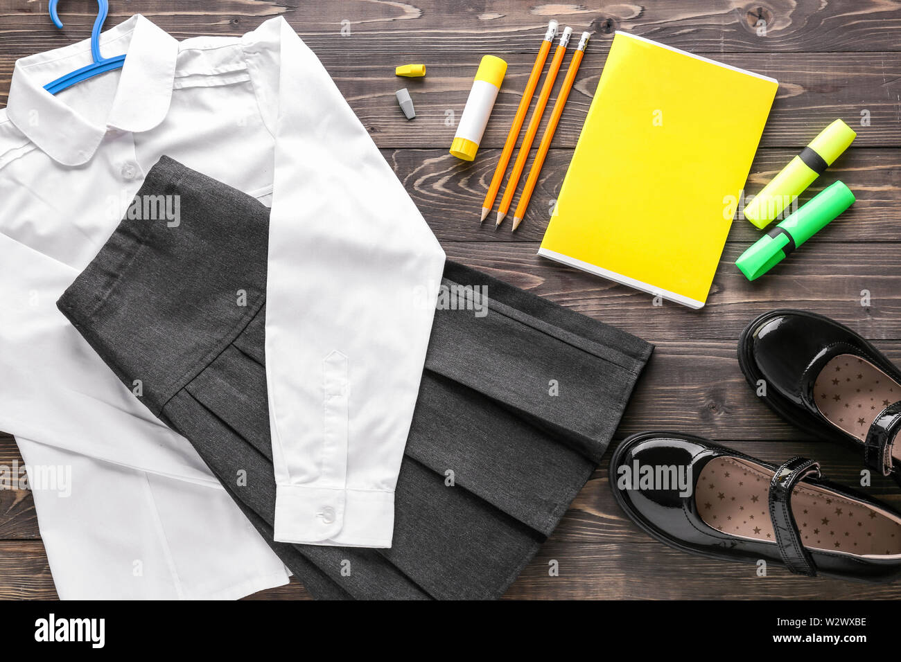 School uniform and stationery on wooden background Stock Photo - Alamy