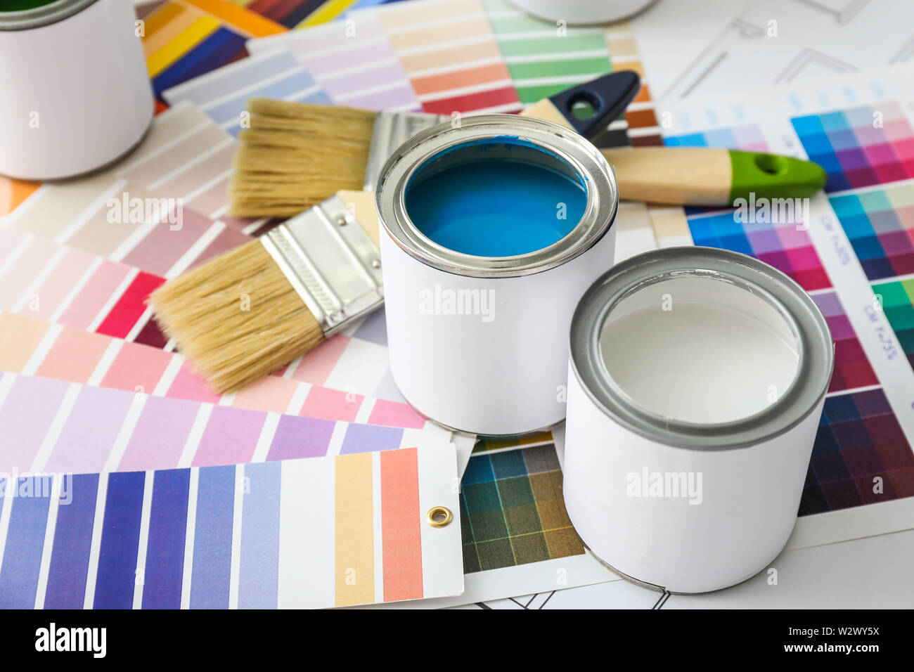 Cans of paint with brushes and palette samples Stock Photo - Alamy