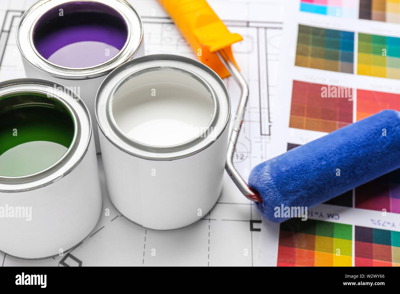 Cans of paint with roller and palette samples Stock Photo - Alamy