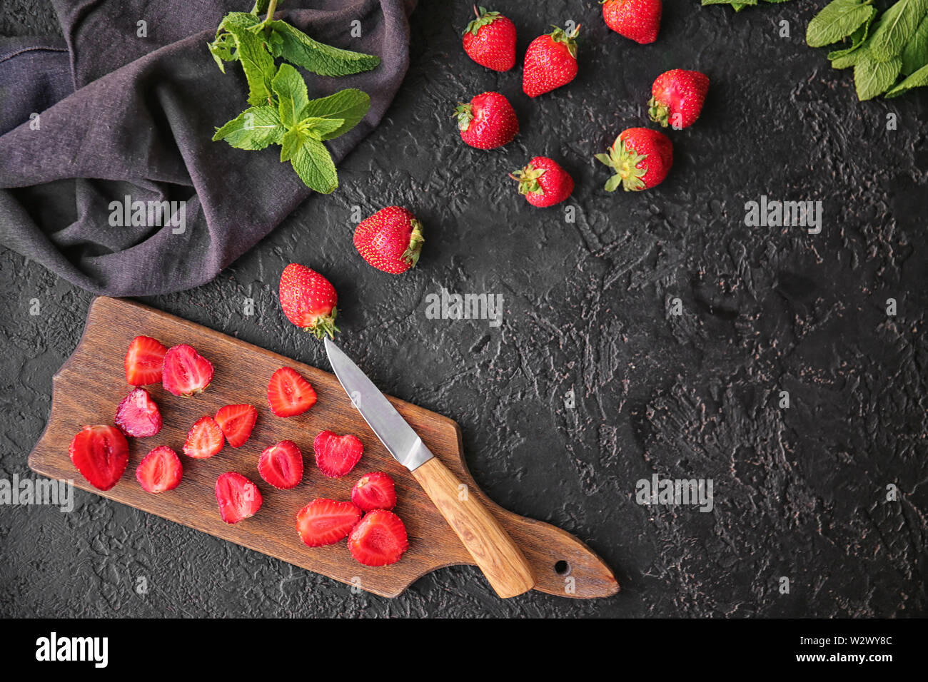 Cutting board with ripe strawberry on dark background Stock Photo - Alamy
