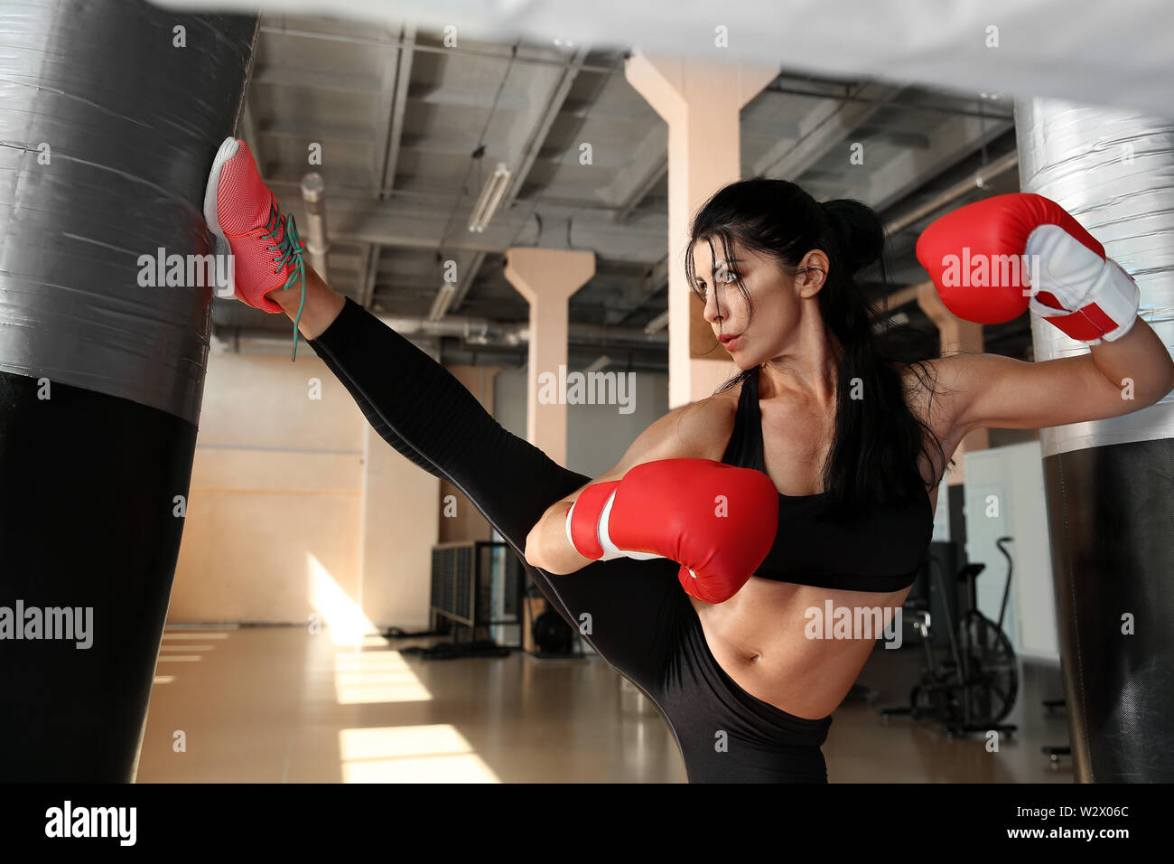 Female kickboxer training with punching bag in gym Stock Photo - Alamy