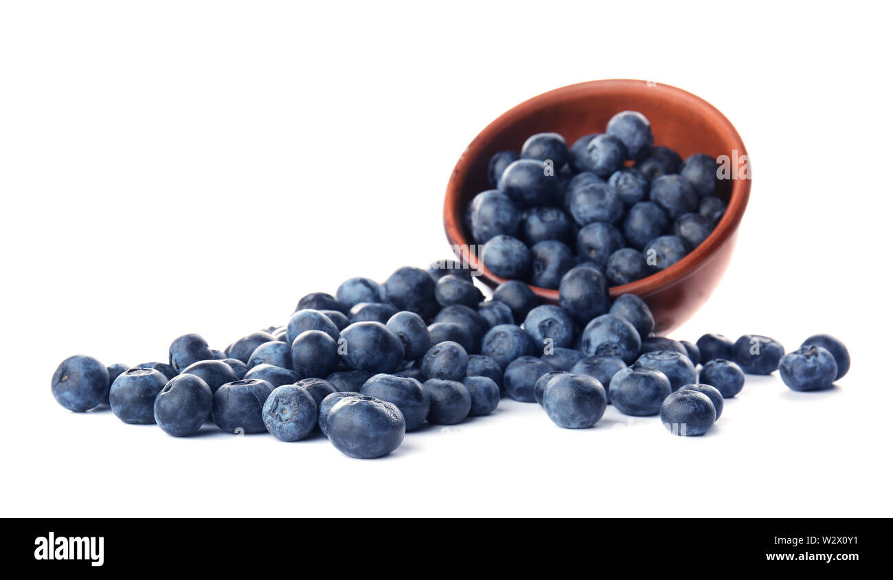 Bowl and scattered blueberry on white background Stock Photo - Alamy