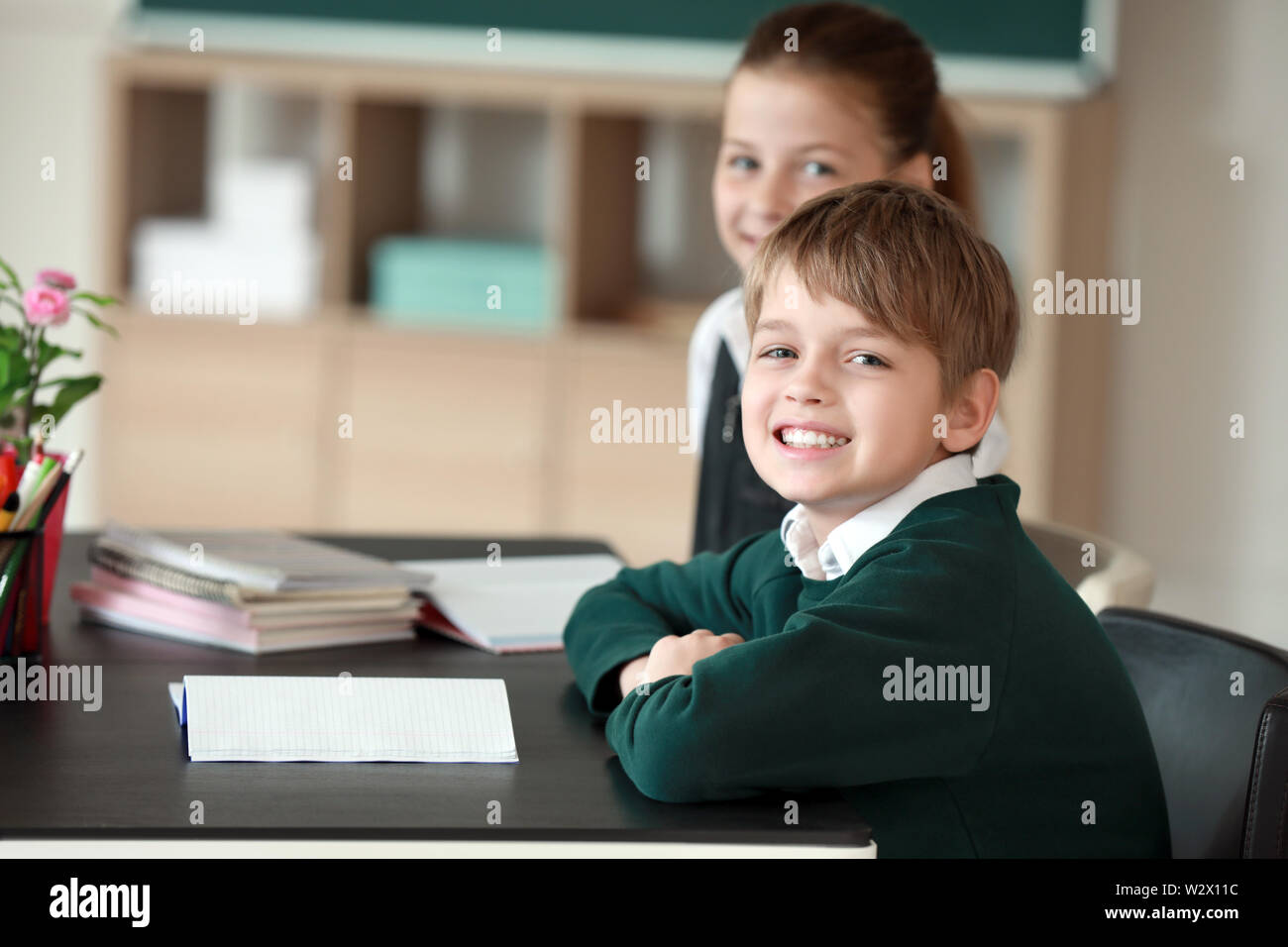 Cute little children during lesson in classroom Stock Photo - Alamy