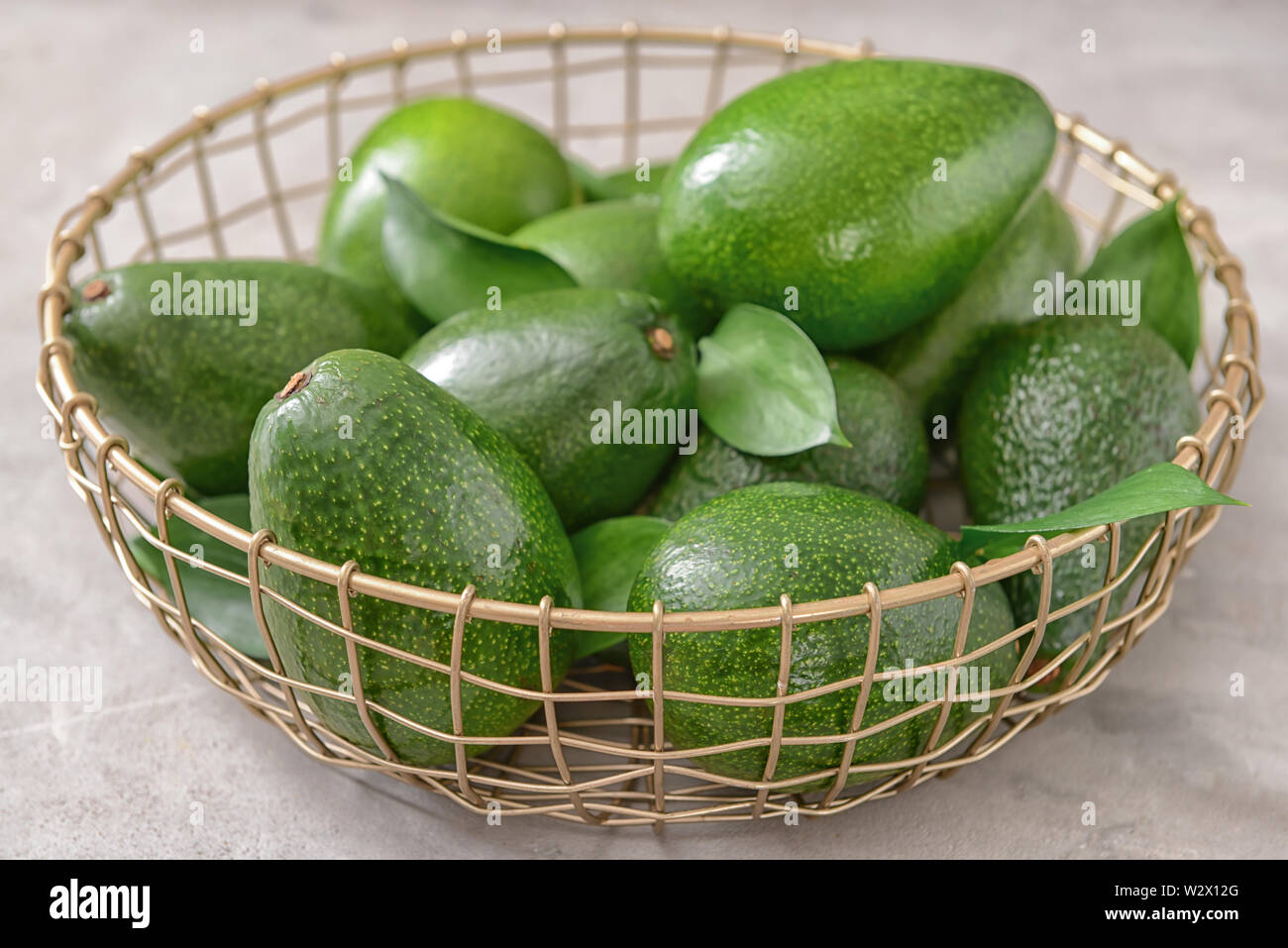 Fresh ripe avocados in basket Stock Photo - Alamy