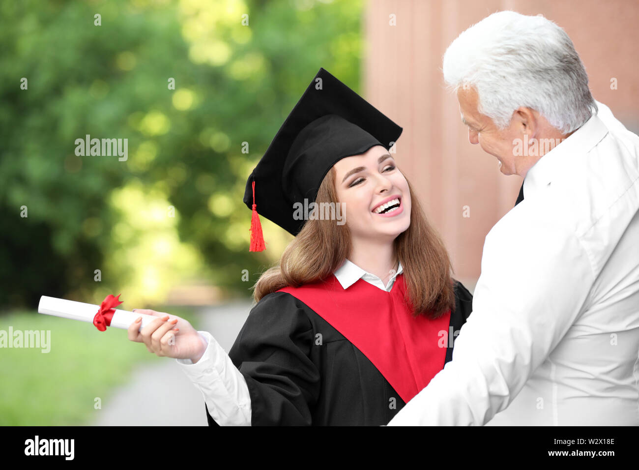 Happy young woman with her father on graduation day Stock Photo - Alamy