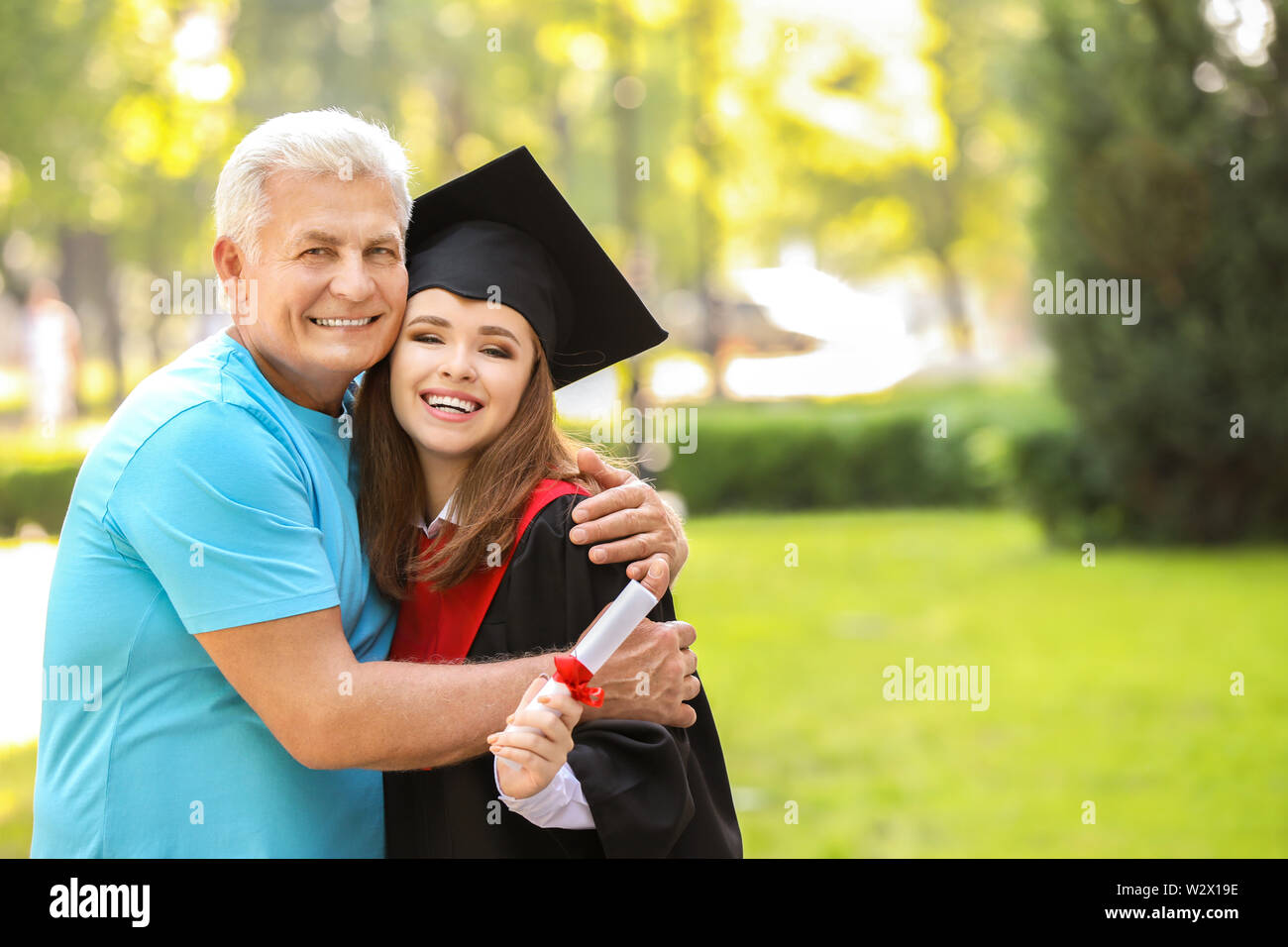 Happy young woman with her father on graduation day Stock Photo - Alamy