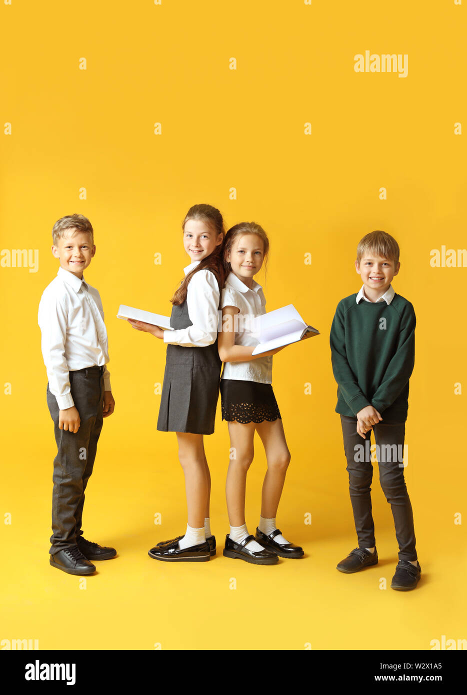 Cute little pupils on color background Stock Photo - Alamy