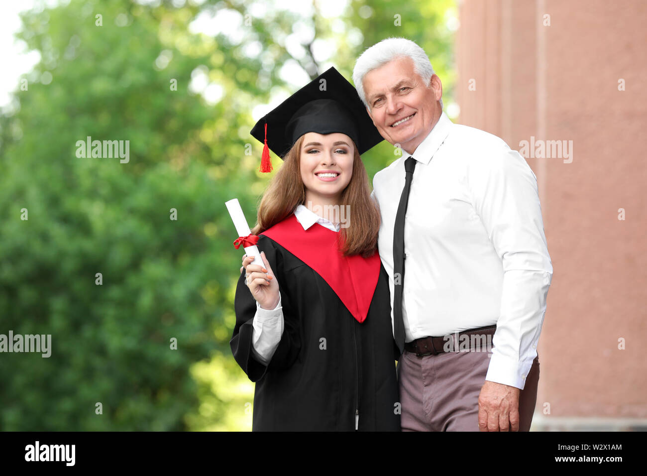 Happy young woman with her father on graduation day Stock Photo - Alamy