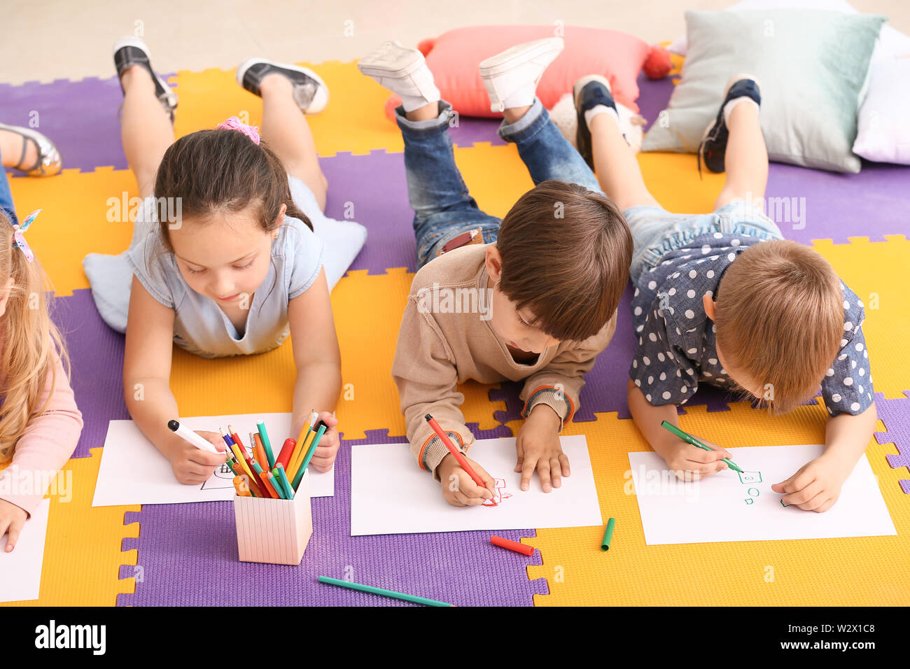 Cute little children drawing in kindergarten Stock Photo - Alamy