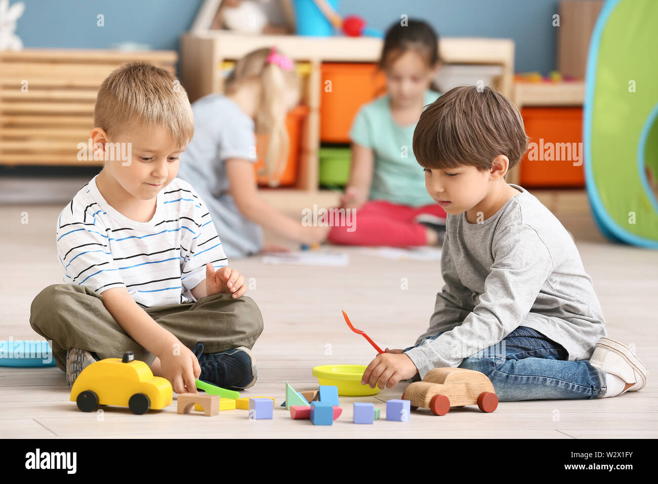 Cute little children playing in kindergarten Stock Photo - Alamy