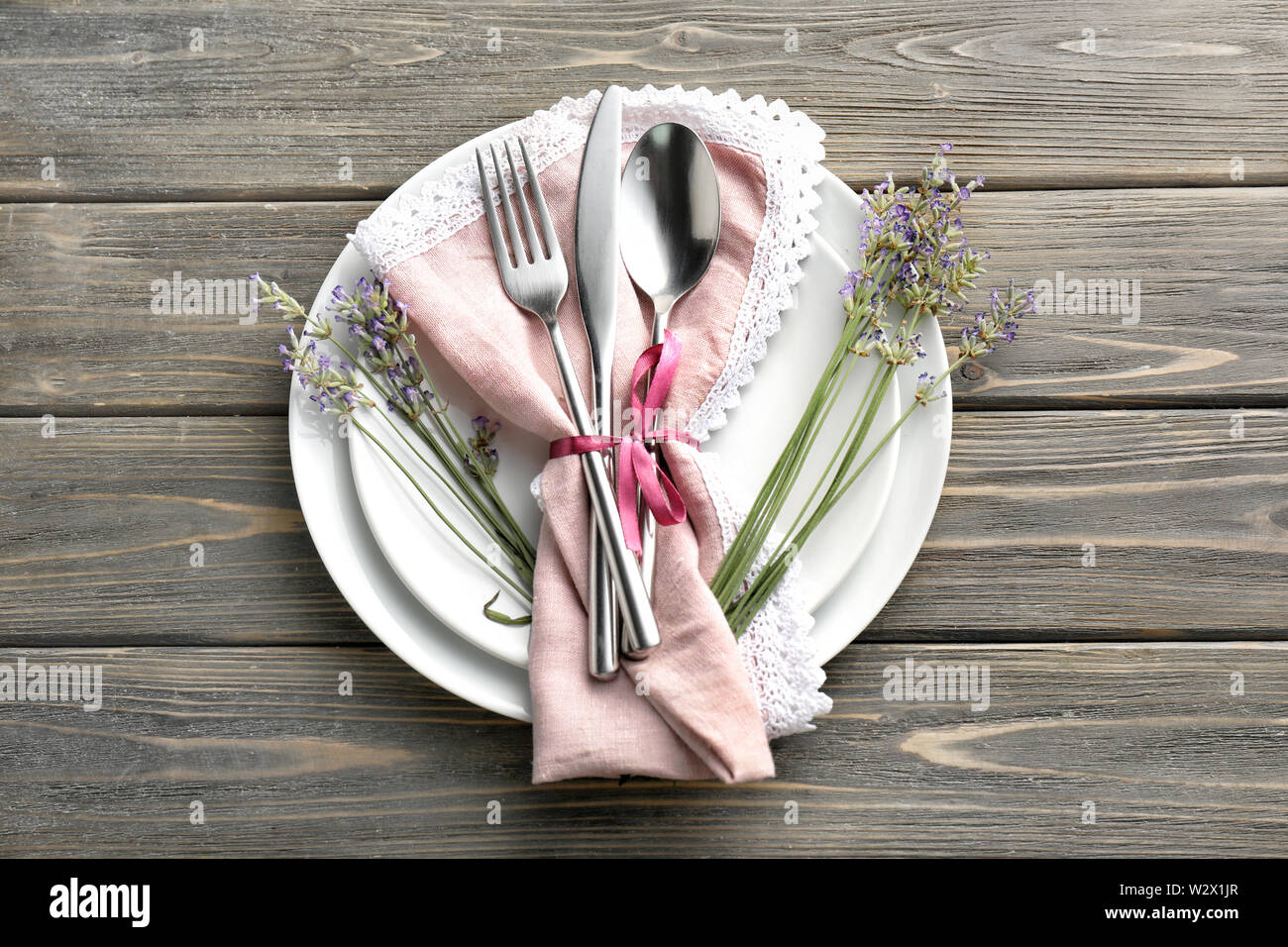 Beautiful table setting on wooden background Stock Photo - Alamy