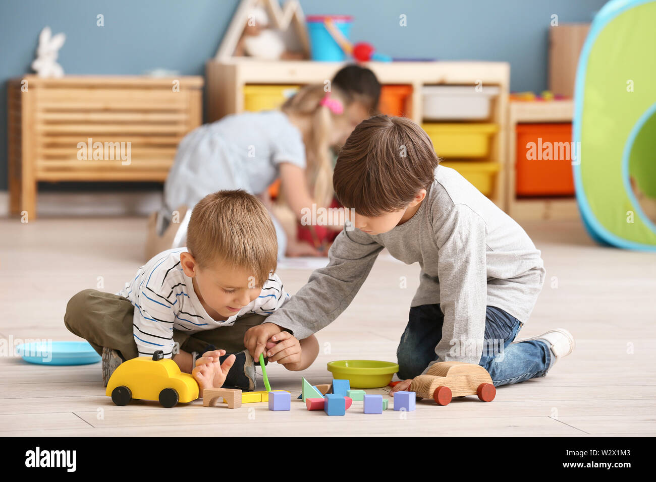 Cute little children playing in kindergarten Stock Photo - Alamy