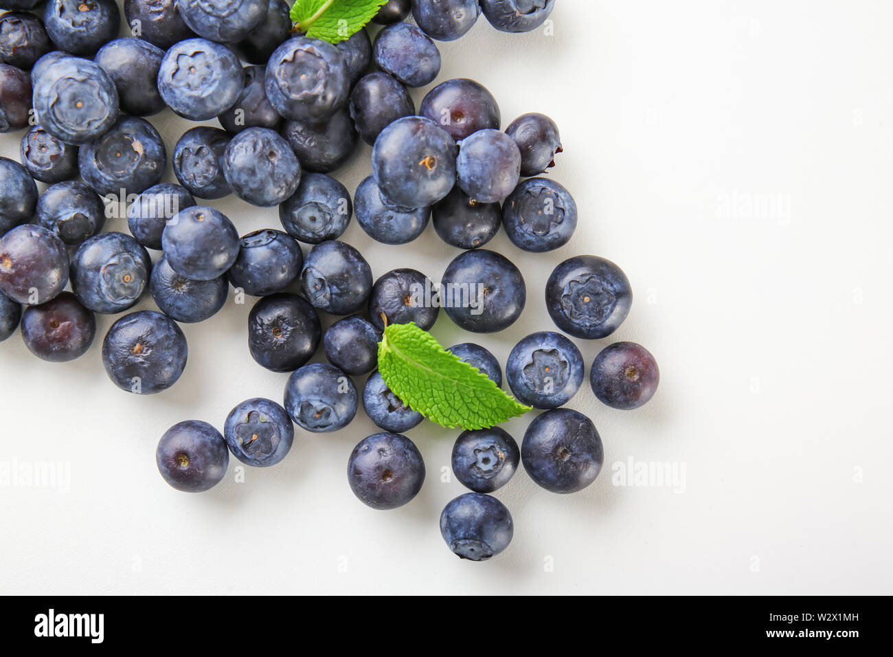 Ripe blueberry on white background Stock Photo - Alamy