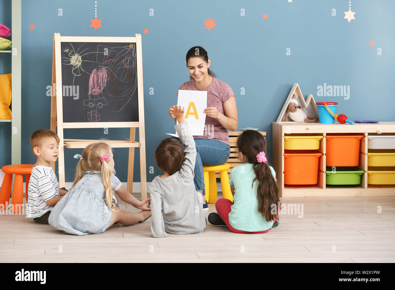 Cute little children learning letters in kindergarten Stock Photo - Alamy