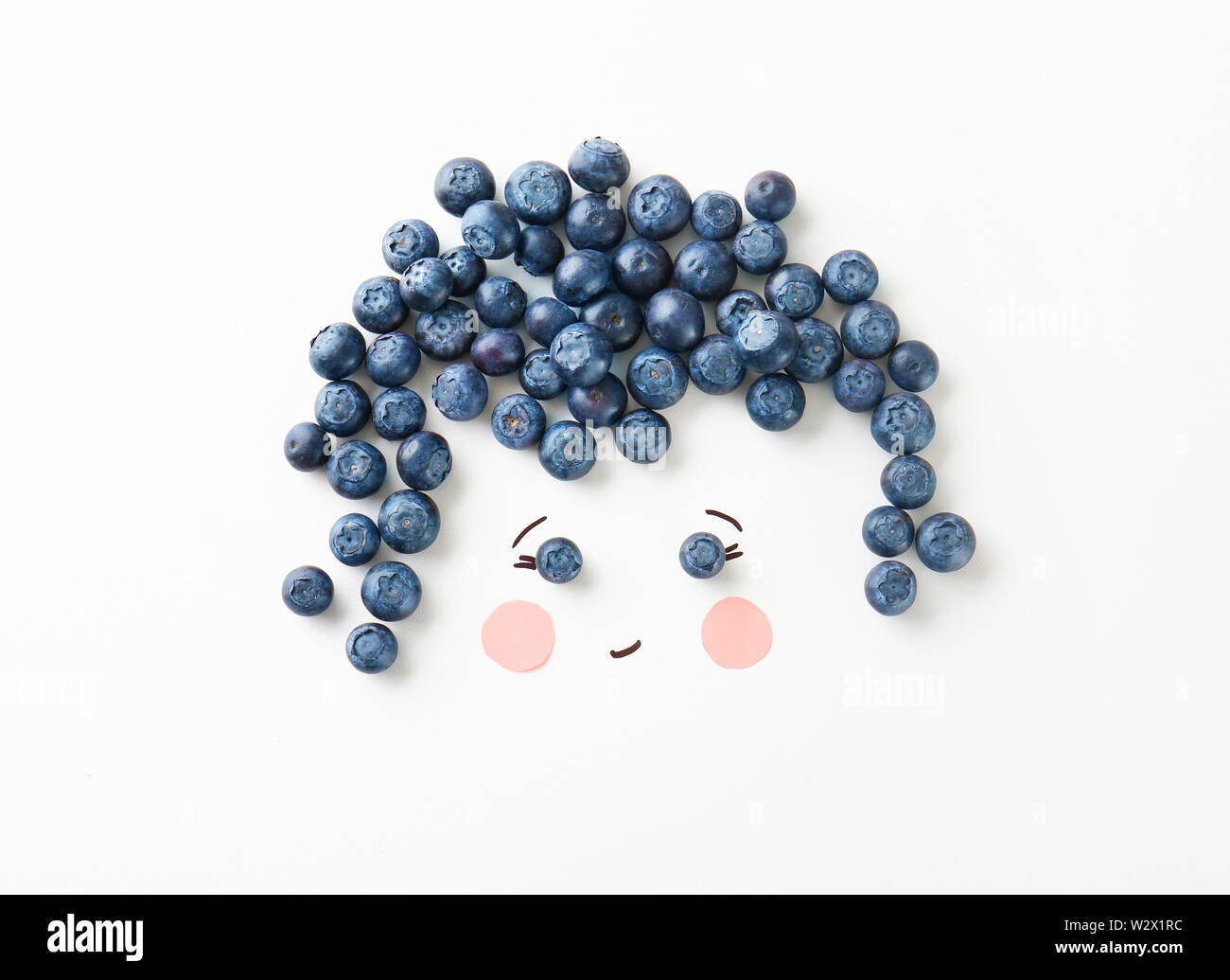 Cute face made of ripe blueberry on white background Stock Photo - Alamy