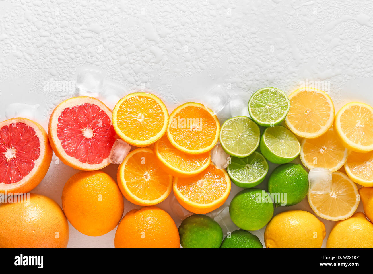 Different cut citrus fruits on white background Stock Photo - Alamy
