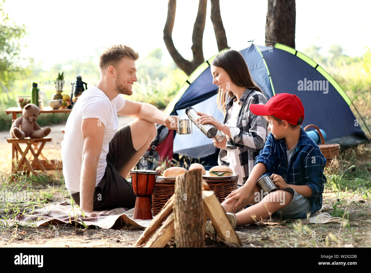 Happy family spending weekend in forest Stock Photo - Alamy