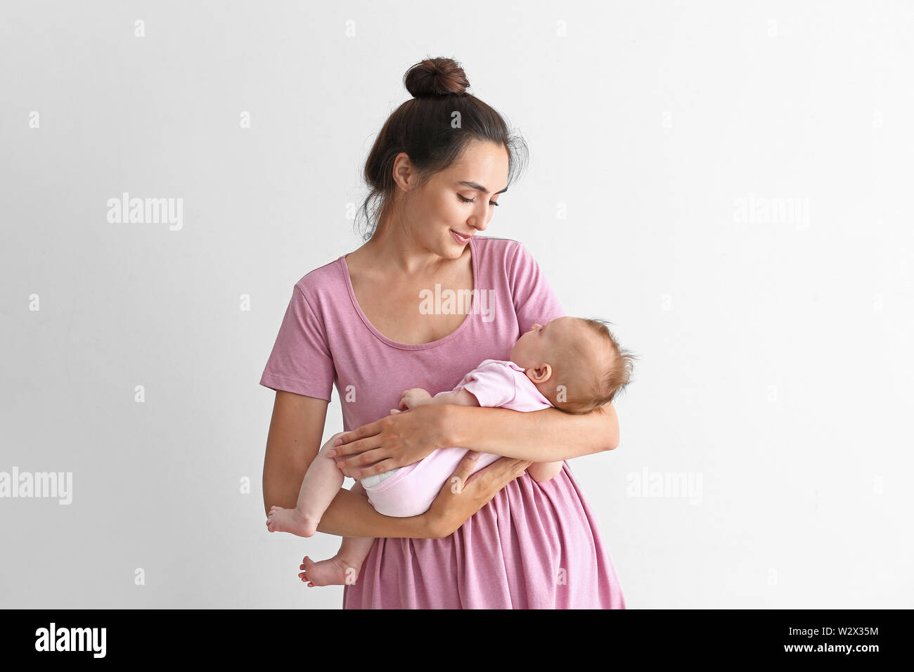 Happy mother with cute little on white background Stock Photo - Alamy