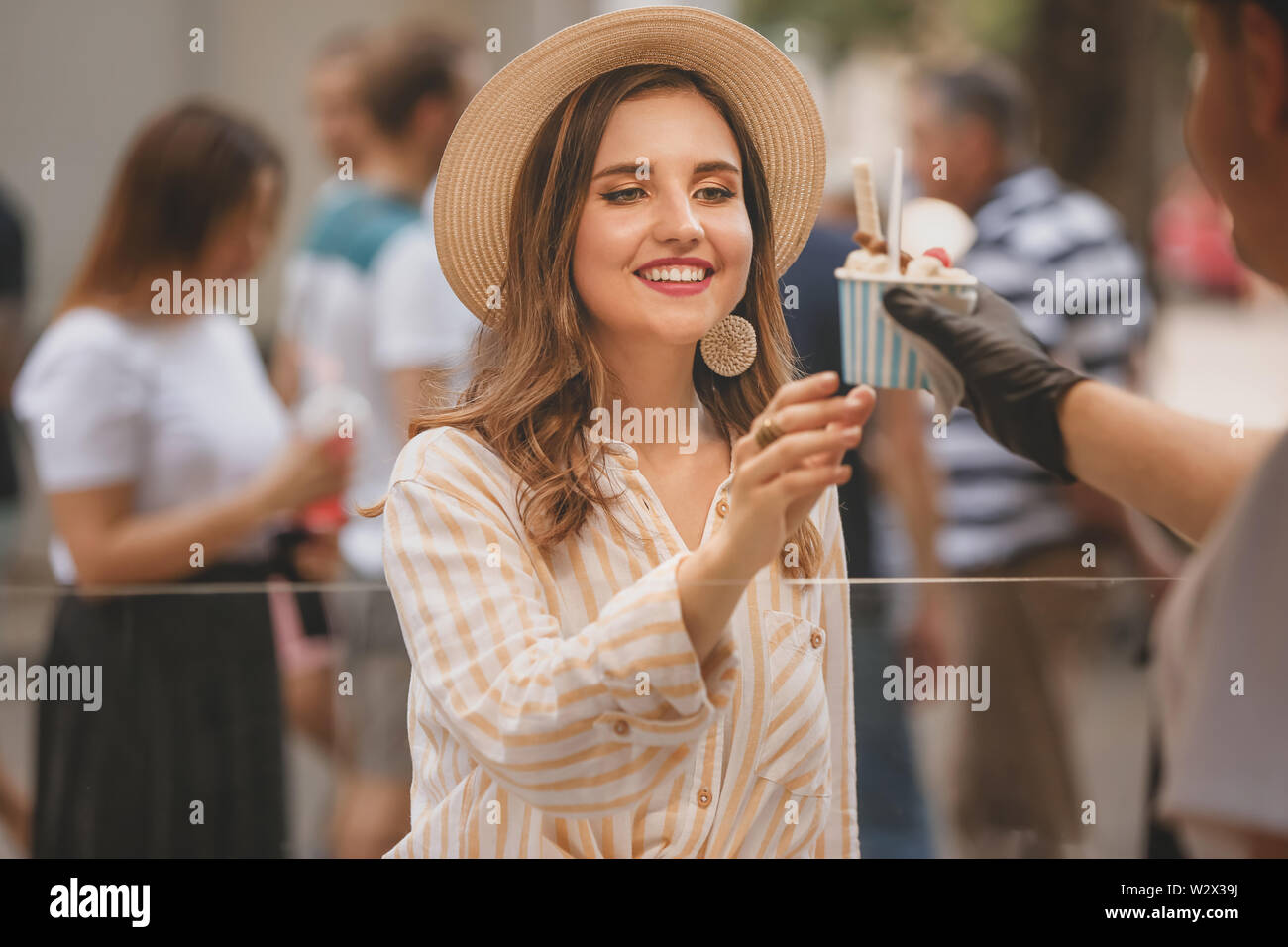 Woman giving ice cream hi-res stock photography and images - Alamy