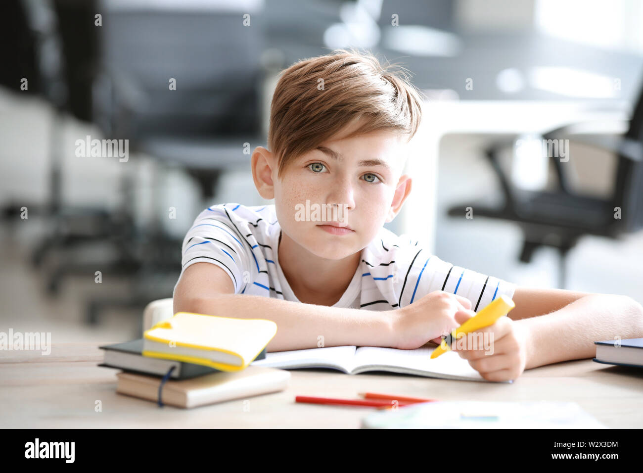 Cute little boy during lesson in classroom Stock Photo - Alamy