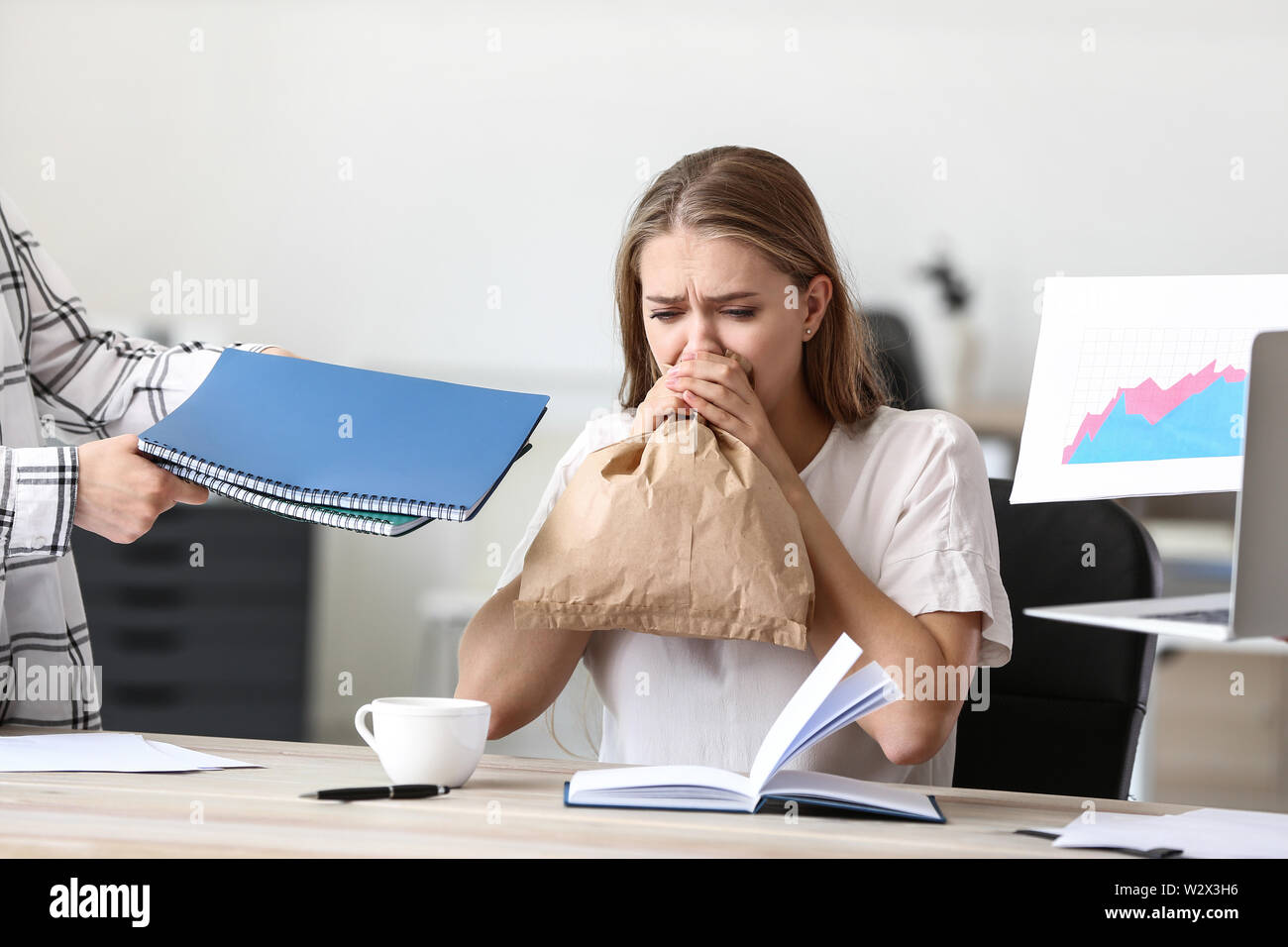 Woman having panic attack at workplace Stock Photo - Alamy
