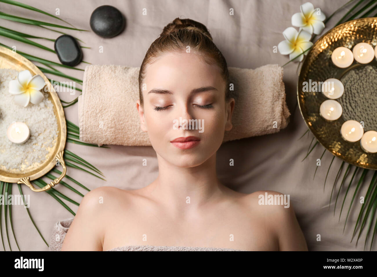 Beautiful young woman relaxing in spa salon, top view Stock Photo - Alamy
