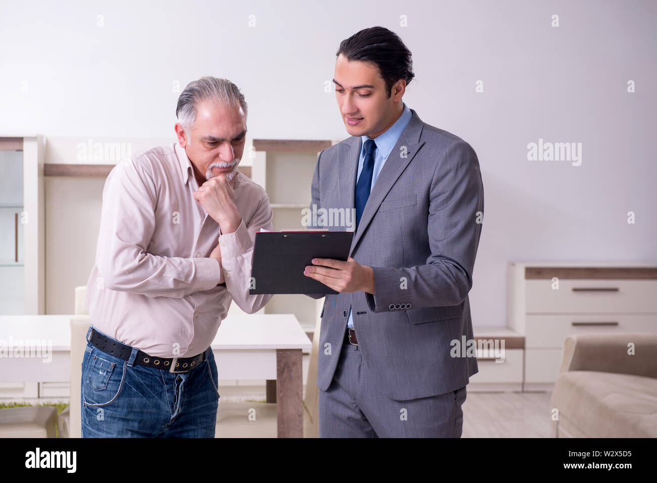 The male real estate agent and male client in the apartment Stock Photo ...
