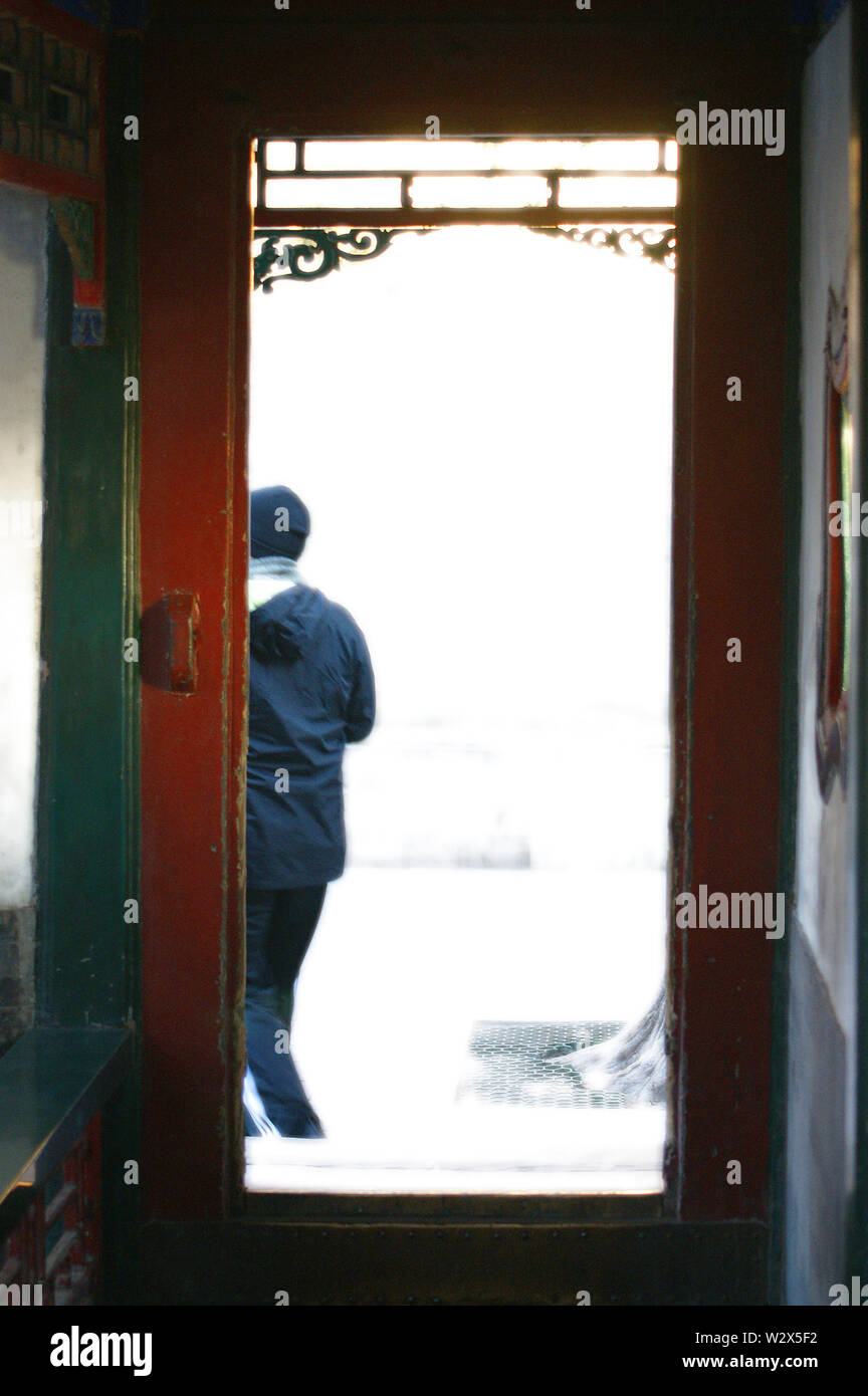 Mystery Man Outside the Red Door Stock Photo - Alamy