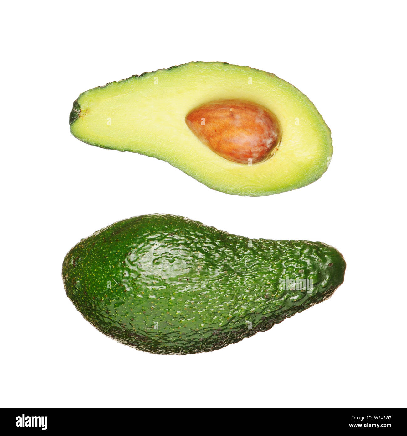 Avocado cut in half and whole isolated on white Stock Photo - Alamy