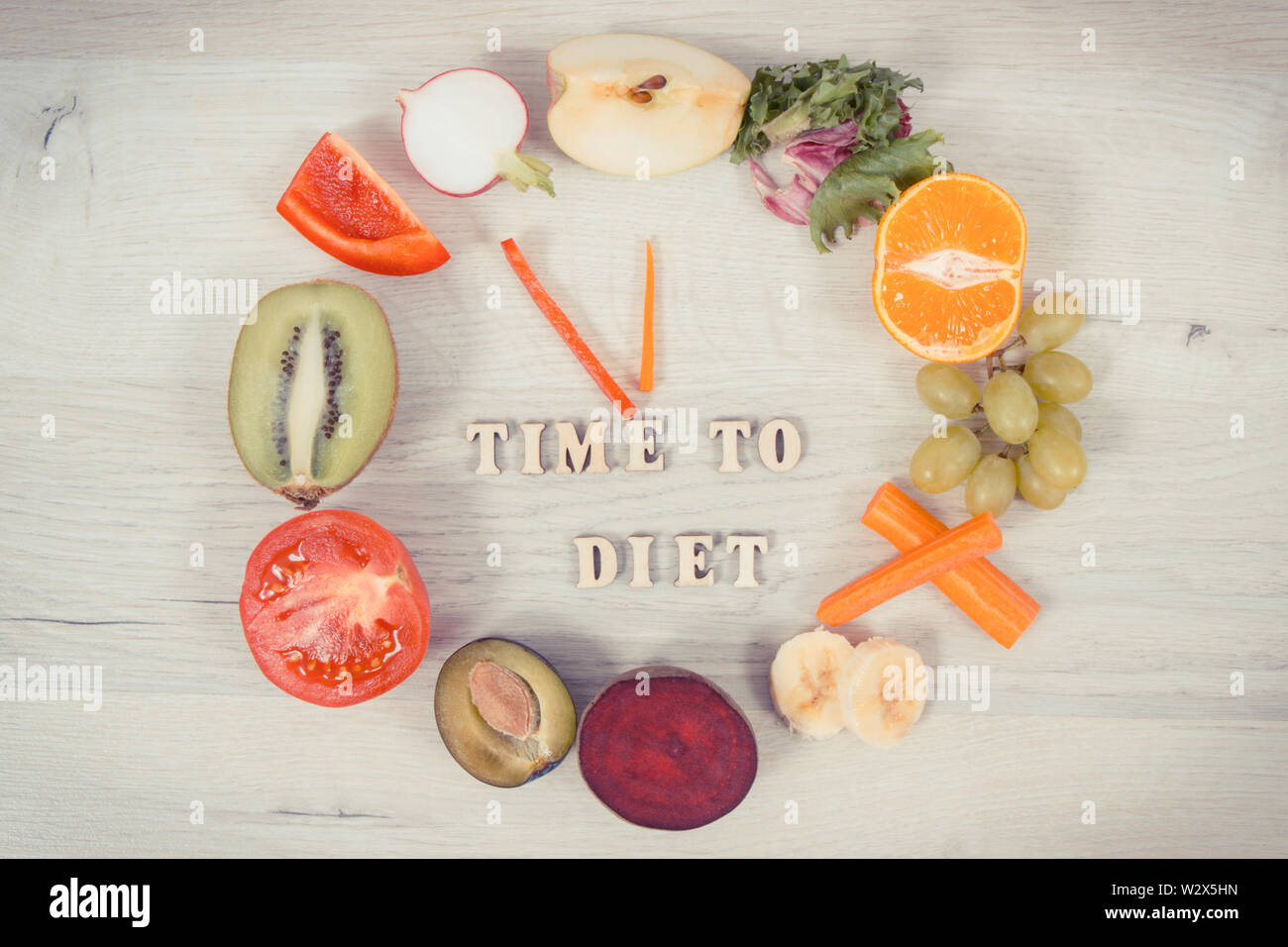 Fresh ripe fruits and vegetables in shape of clock showing time to diet ...