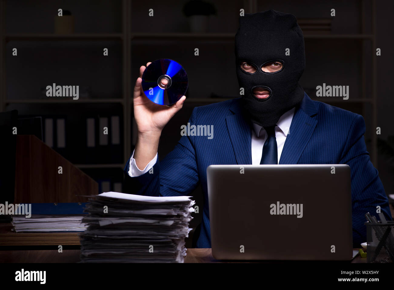 The male employee stealing information in the office night time Stock ...