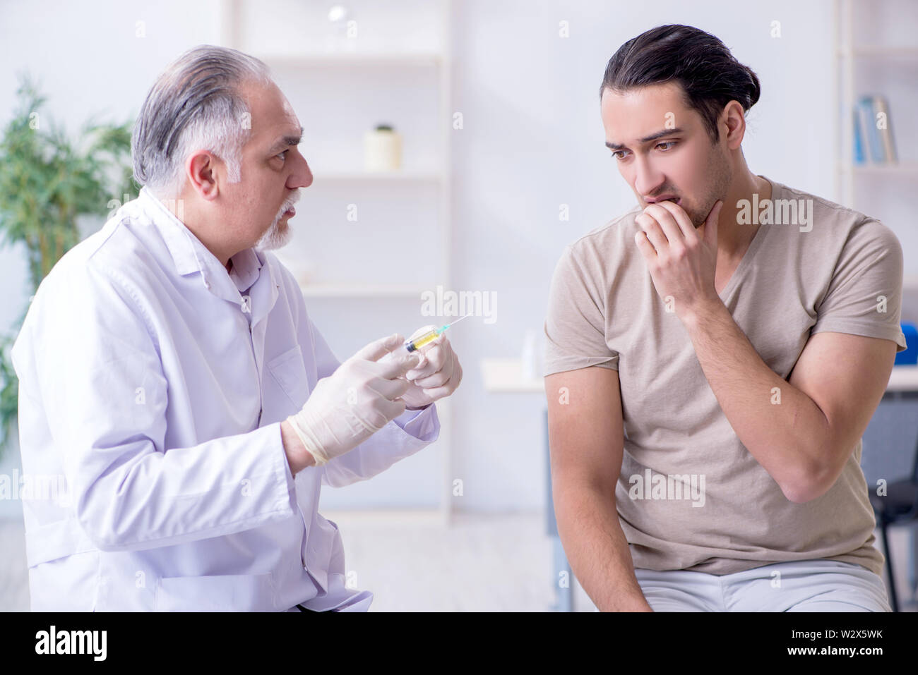 The male patient visitng doctor for shot inoculation Stock Photo - Alamy